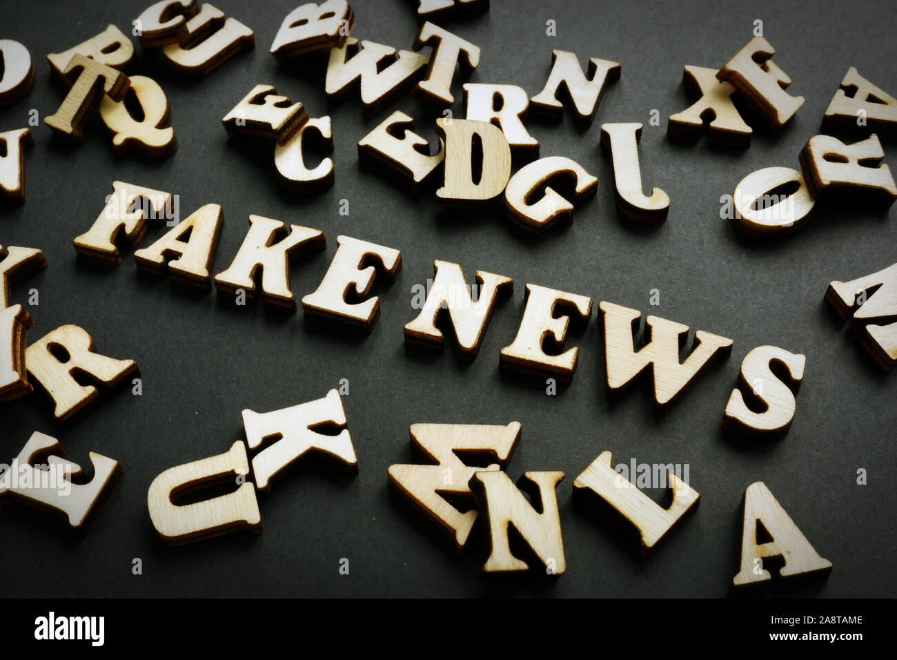 Fake news concept. Letters on the black desk Stock Photo - Alamy