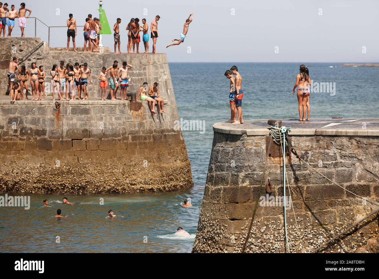 Teenagers jump into the sea hi-res stock photography and images - Alamy