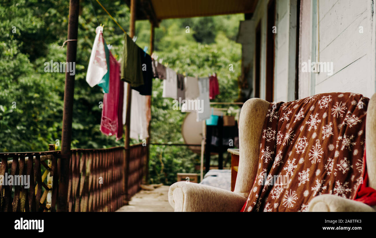 Clothes drying on rope line on a balcony - rural life. The interior of ...