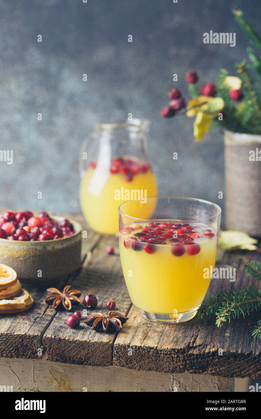 Spice fruity orange punch with cranberry in glass on wooden table Stock ...