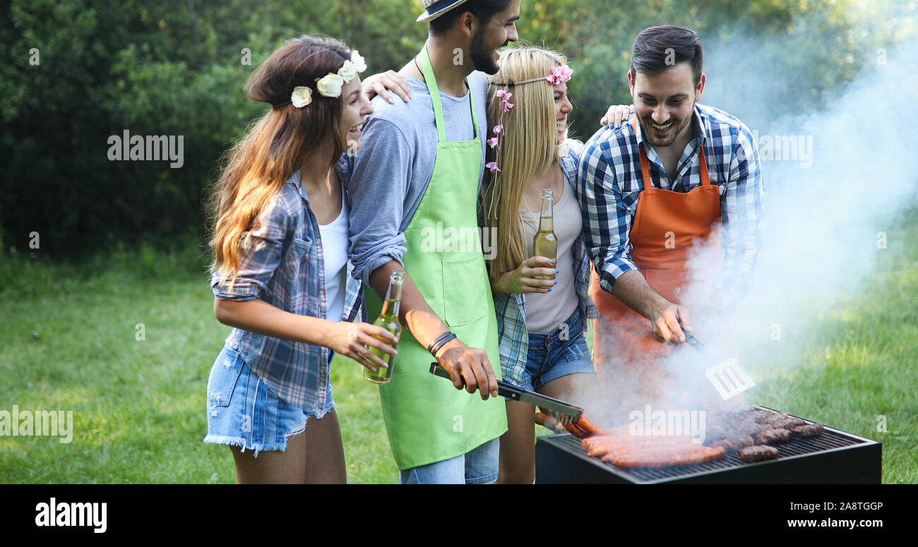 Group of friends making barbecue in Stock Photo - Alamy