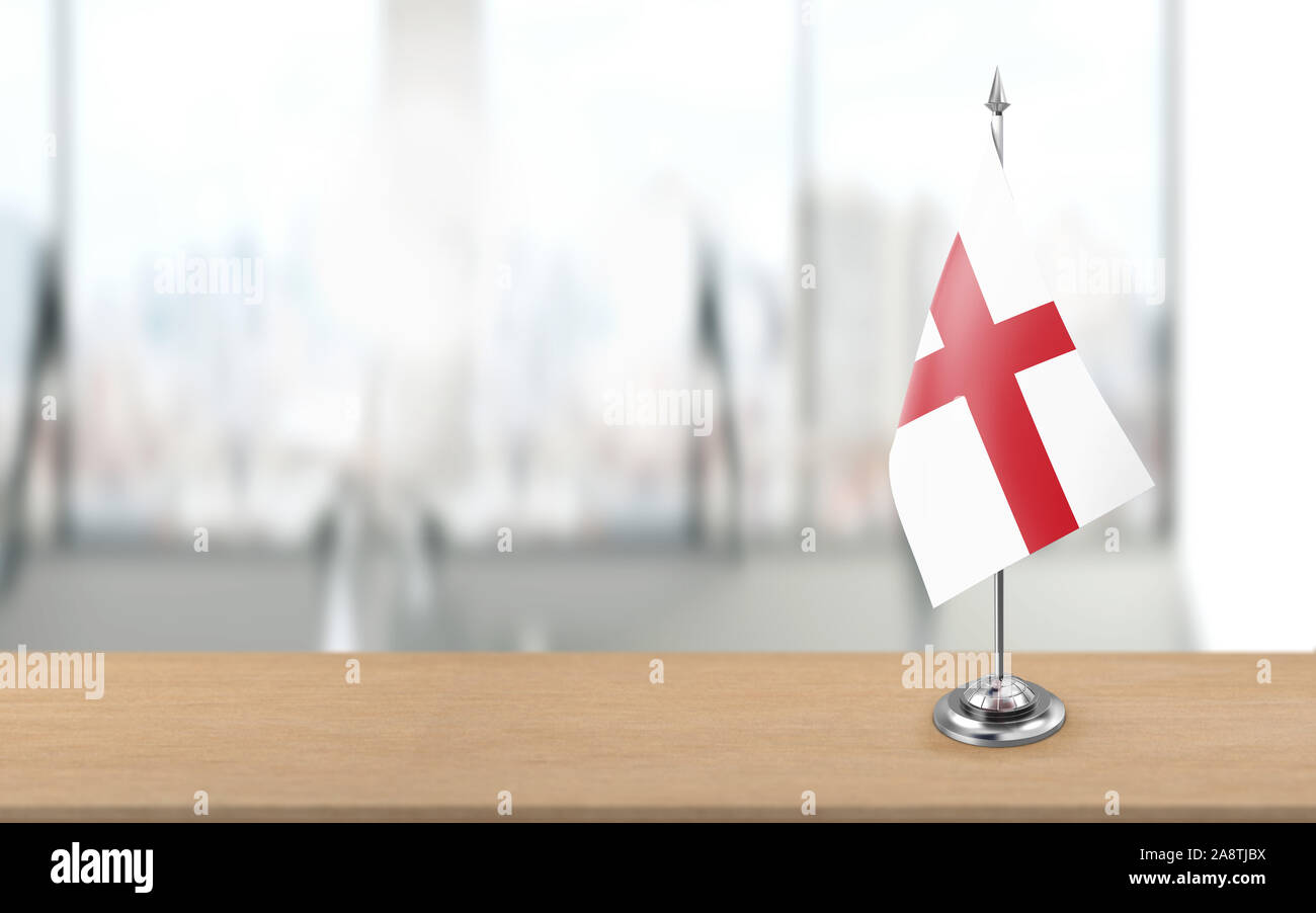 English flag is standing on a metal pole is at wooden office table ...