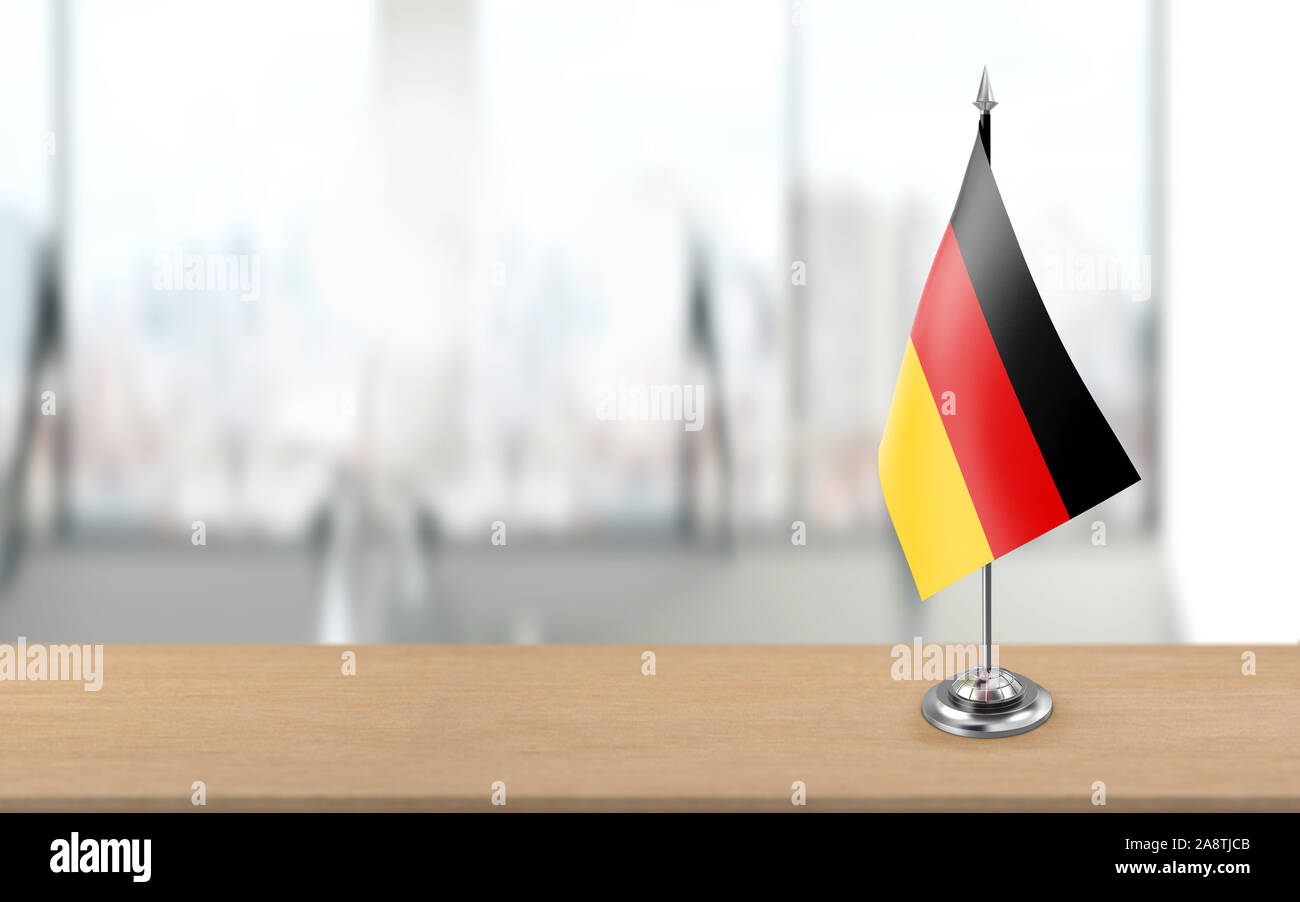 German flag is standing on a metal pole is at wooden office table. High ...