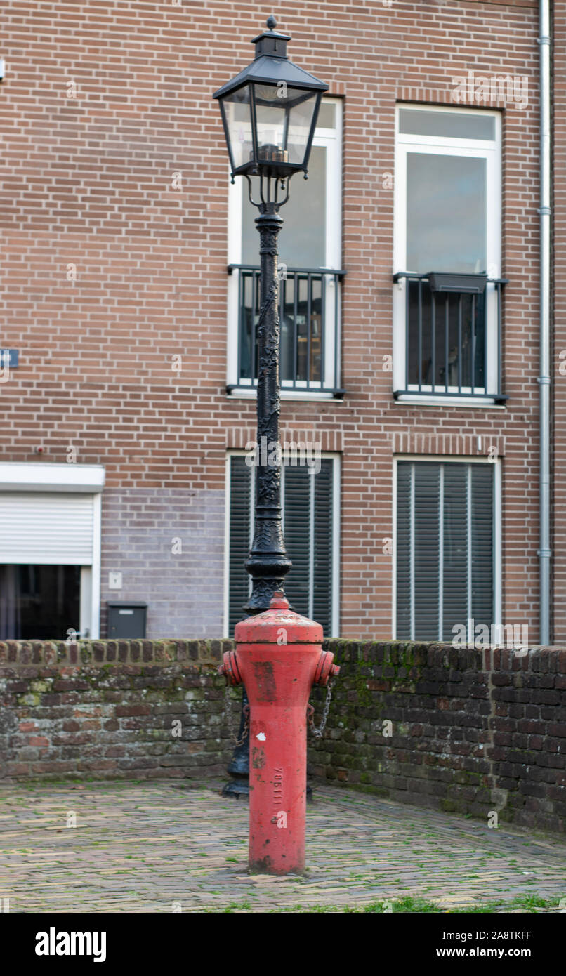 A Typical old Dutch red Hydrant standing in the City Stock Photo - Alamy