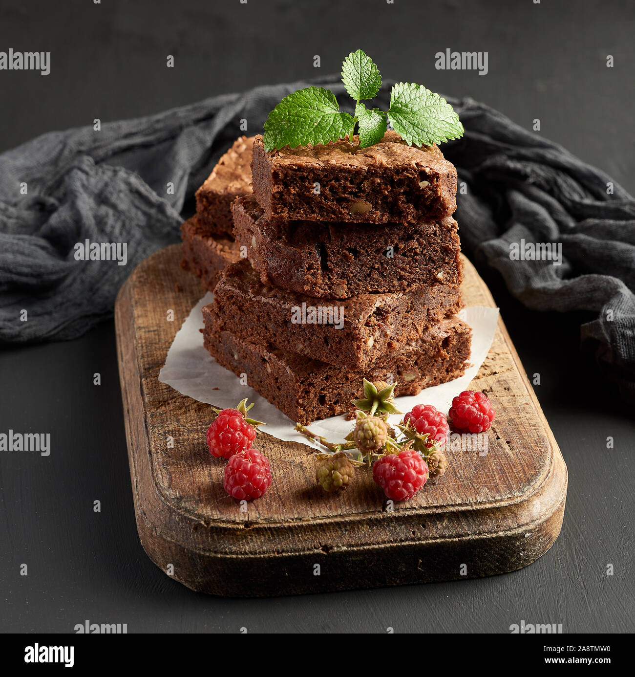 stack of baked square pieces of chocolate brownie cake on brown wooden ...