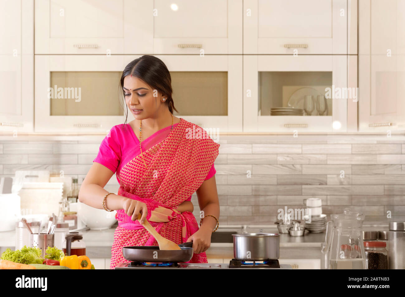 woman in saree cooking in the kitchen Stock Photo - Alamy