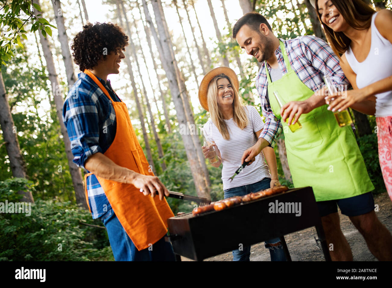 Friends having fun in nature doing bbq Stock Photo - Alamy