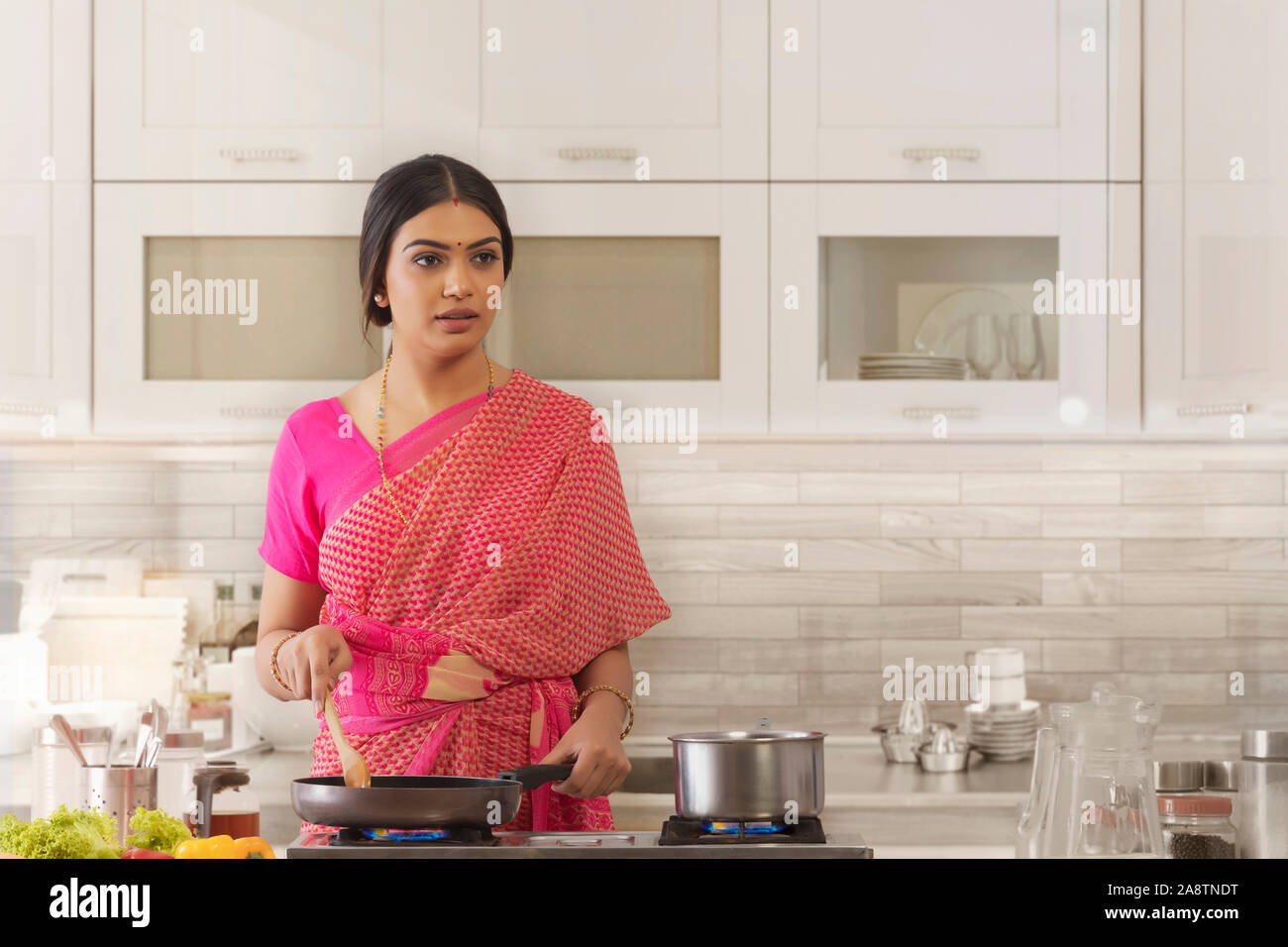 woman in saree cooking in the kitchen Stock Photo - Alamy