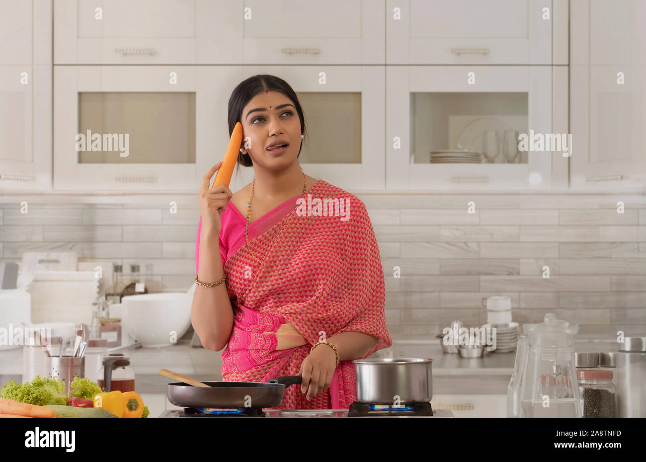 woman in kitchen thinking about dishes Stock Photo - Alamy