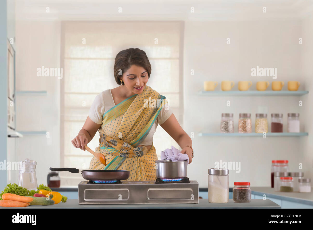woman preparing food in kitchen Stock Photo - Alamy