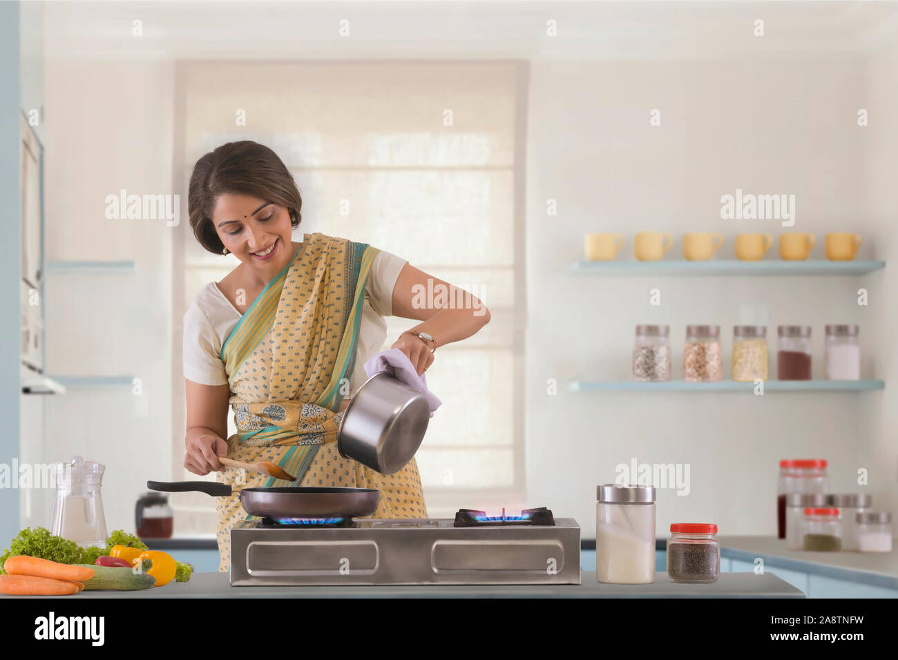 Woman preparing food in kitchen hi-res stock photography and images - Alamy