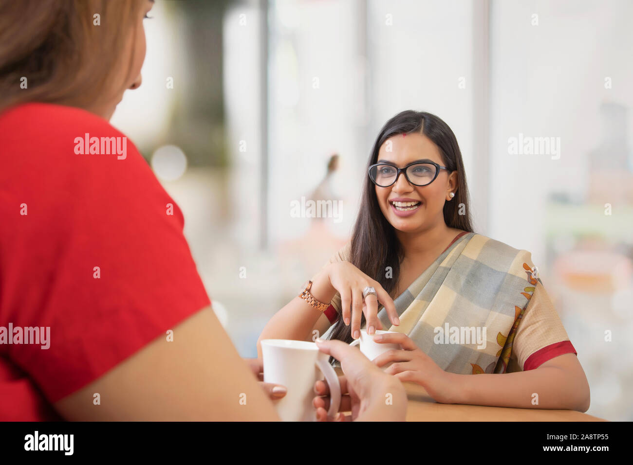 two colleagues having tea Stock Photo - Alamy