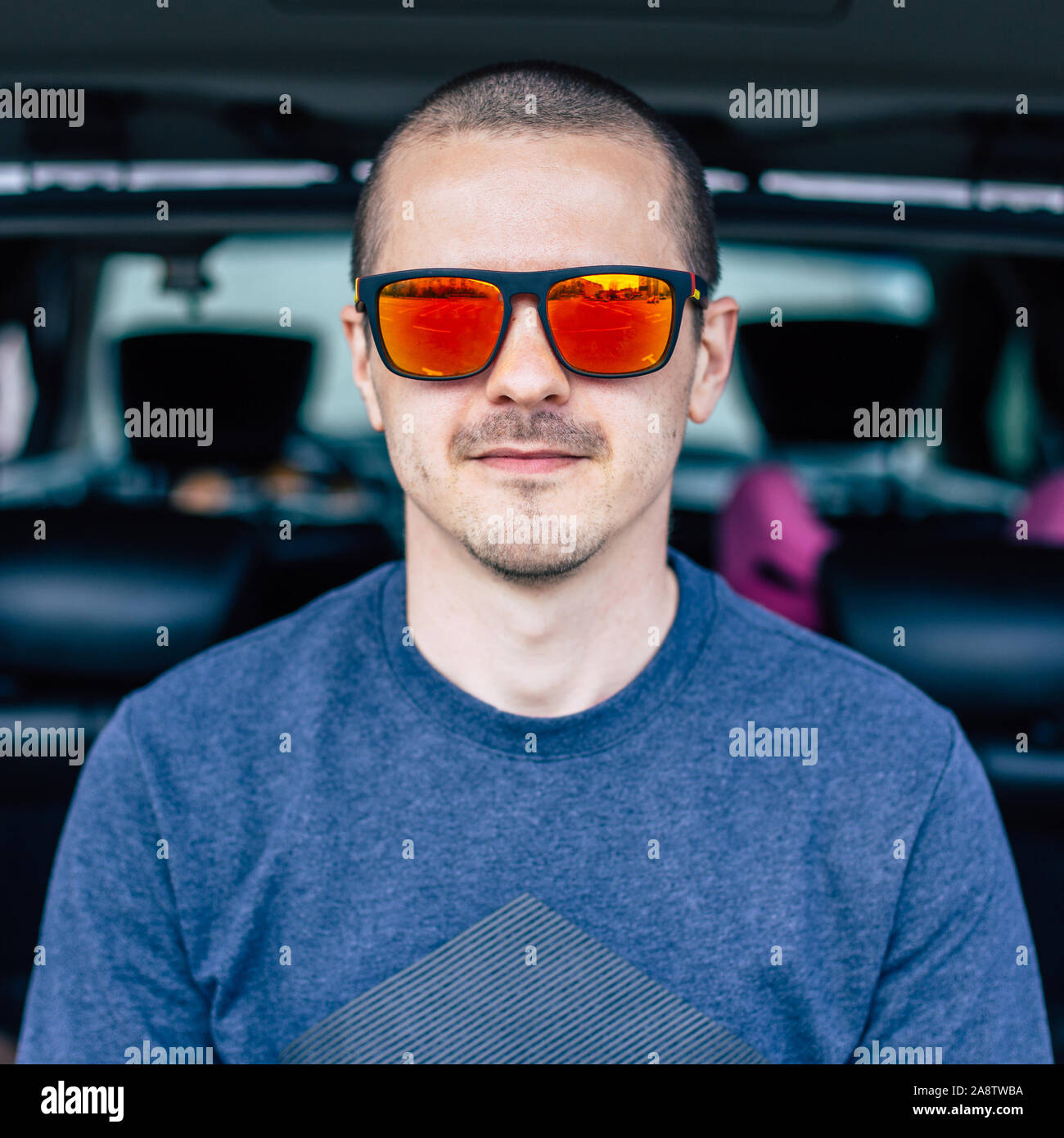 Portrait of man in red sunglasses looking forward in camera Stock Photo ...