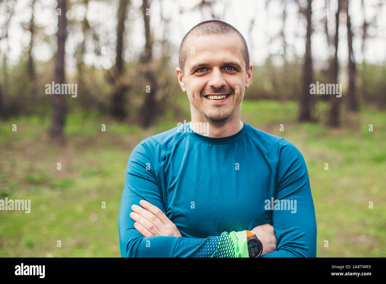 Portrait of sportsman in the forest looking in camera Stock Photo - Alamy