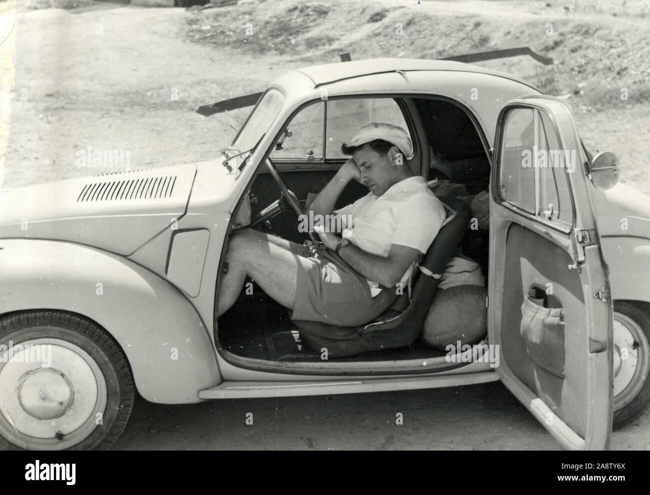 Man sleeping in his FIAT 500 Topolino, Italy 1930s Stock Photo - Alamy