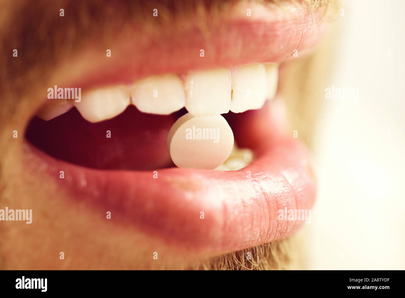 Guys mouth with round pink drug, close up. Medical treatment or health ...