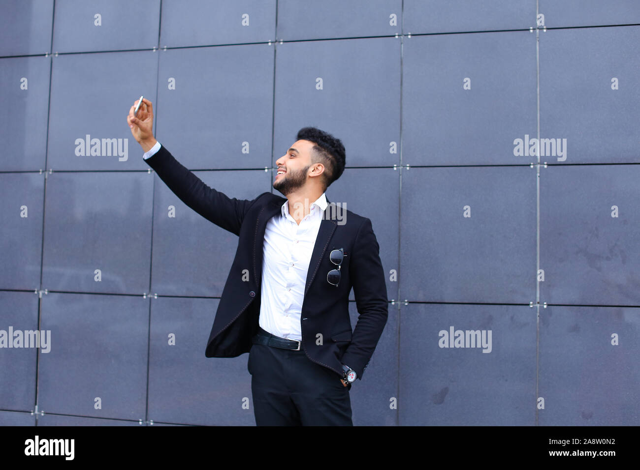 Handsome arabic man takes selfie smart phone in business center Stock ...