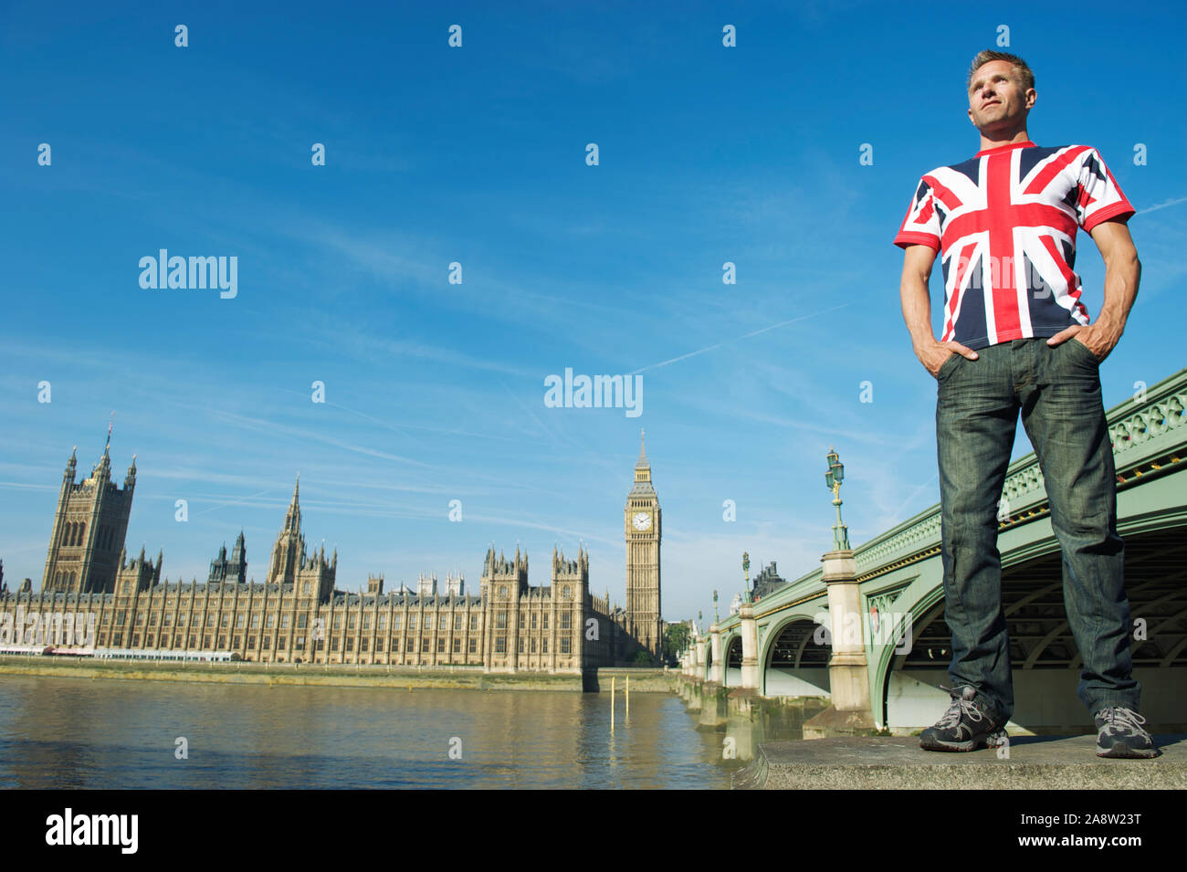 Patriotic young British man in Union Jack T-shirt standing in front of ...