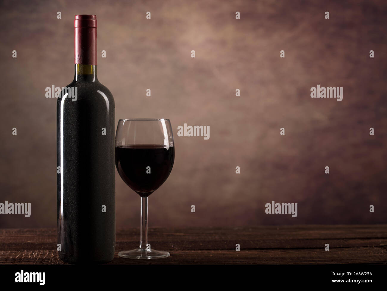Red Wine in glass and buttle with dust on dark background with copy ...