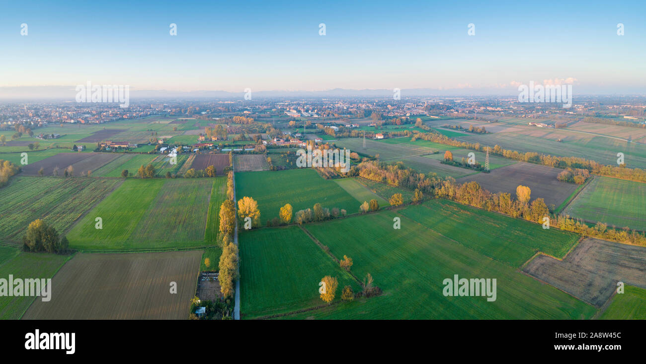 Countryside panorama on the outskirts of a city. Top view at sunset ...
