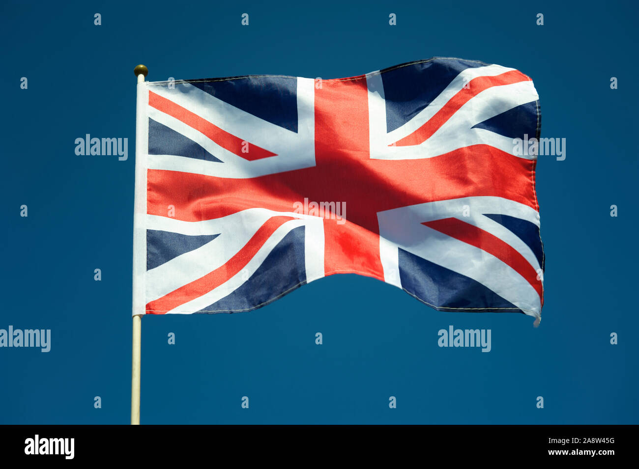Single British Union Jack flag flying on a flag pole in sunny bright ...