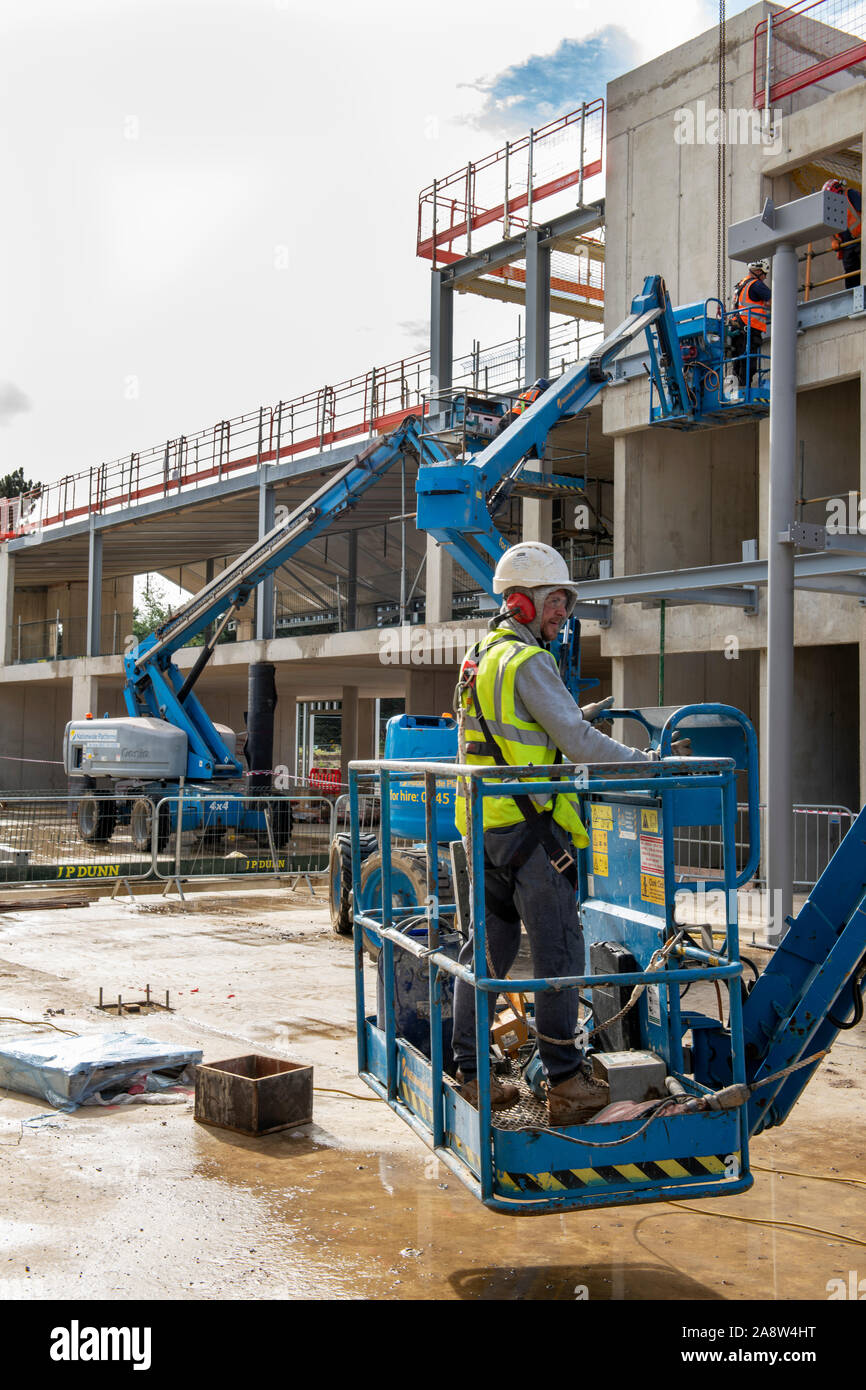 cherry picker working on a building site Stock Photo - Alamy