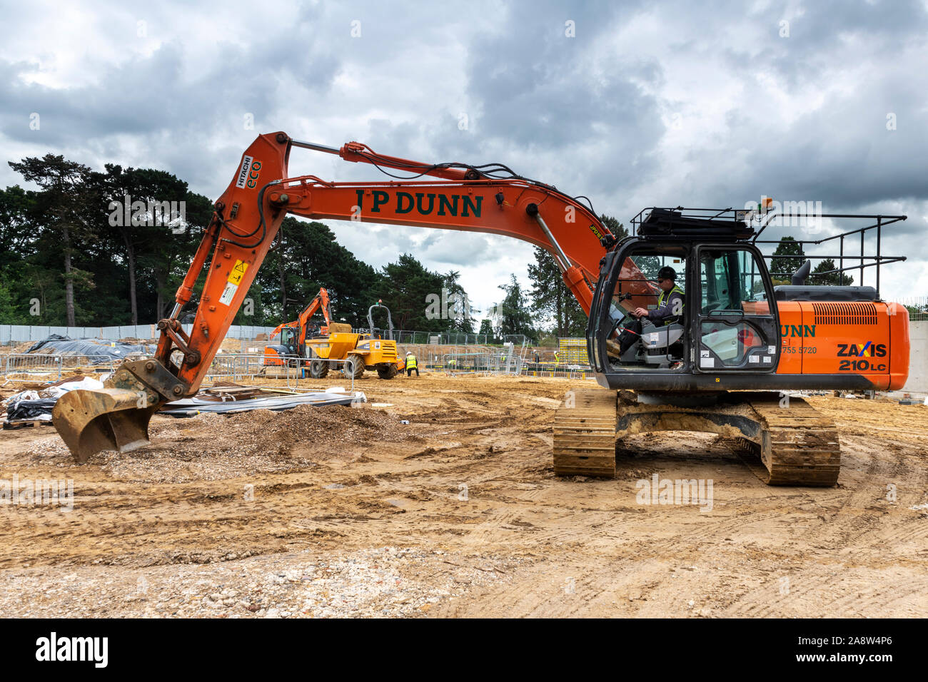 Crane moving earth on building construction site Stock Photo - Alamy