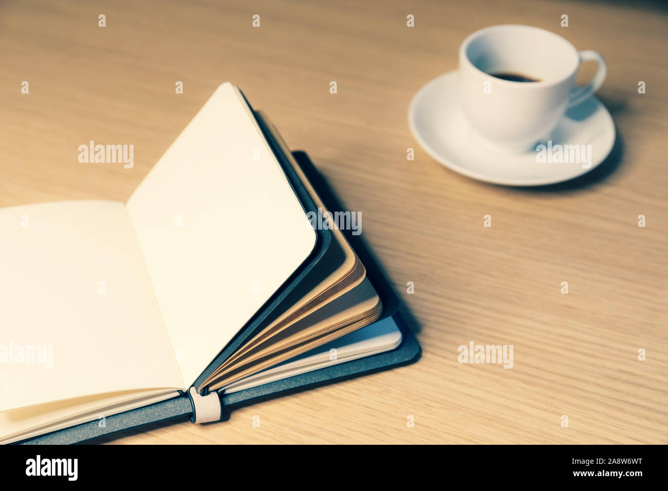 Office desk table with note book open and coffee cup Stock Photo - Alamy
