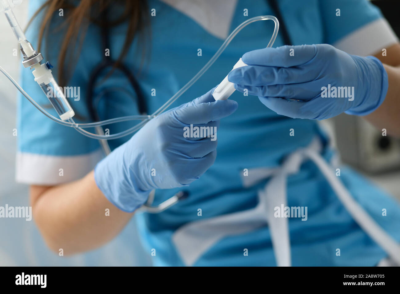 Female nurse hand in blue protective gloves hold dropper Stock Photo ...