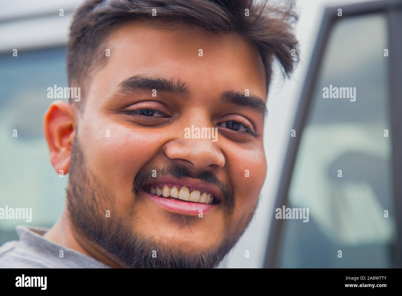 Closeup portrait, young happy handsome man portrait, outdoor in nature ...
