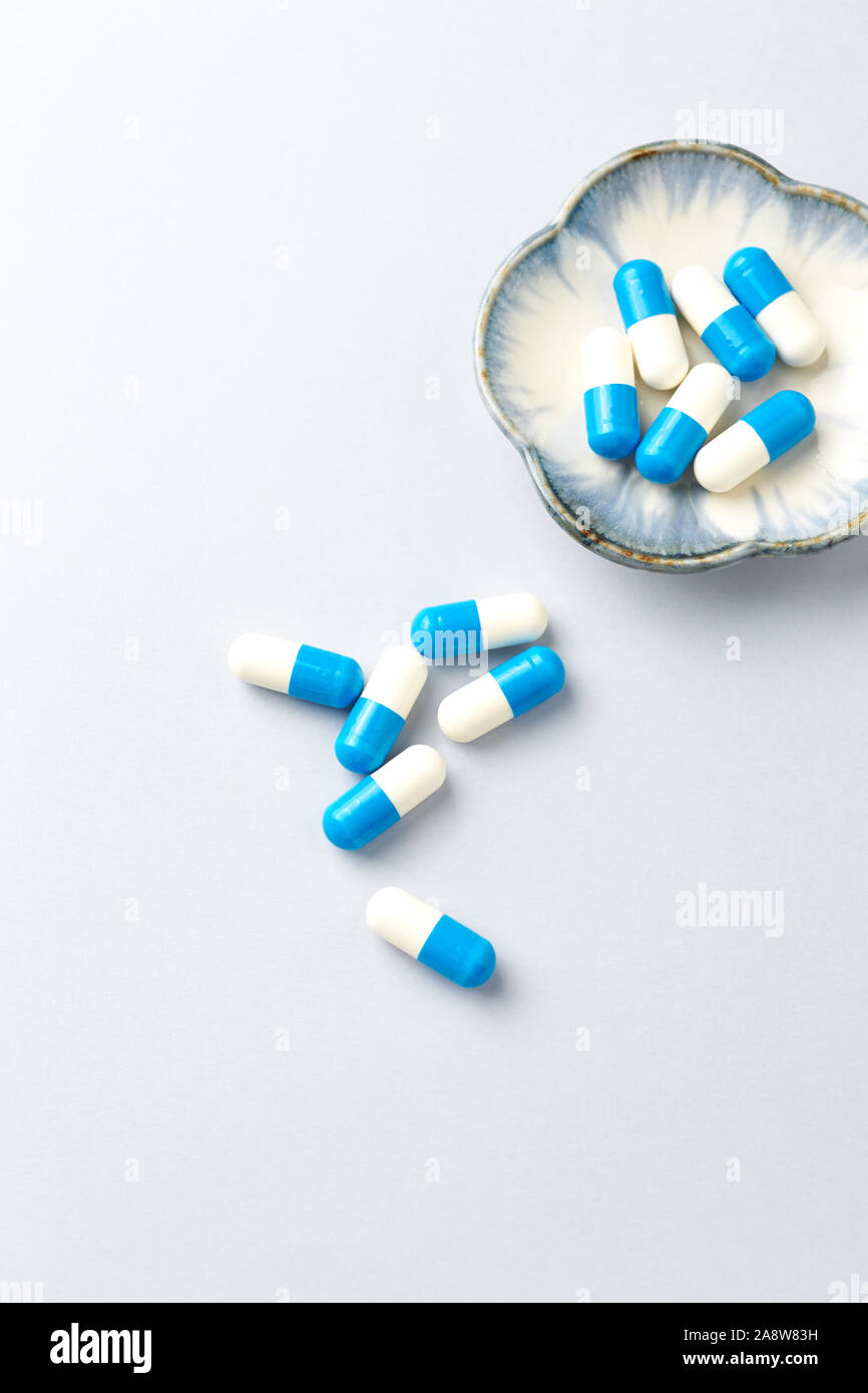 Creatine capsules. Sports supplements on bright paper background. Copy ...