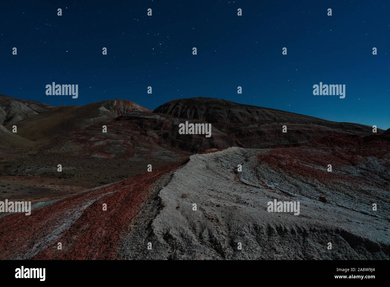 Amazing striped red mountains on a moon night Stock Photo - Alamy