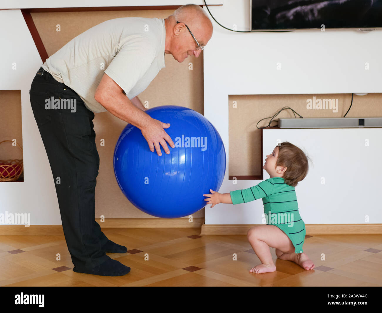 Grandfather plays ball with his grandson. The relationship between ...