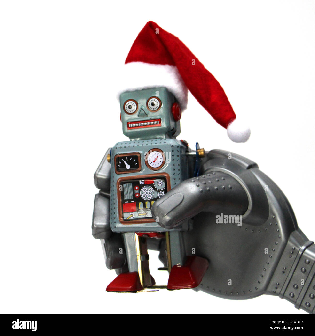 The robot holds a small retro robot in his hand. The robot has a Santa ...