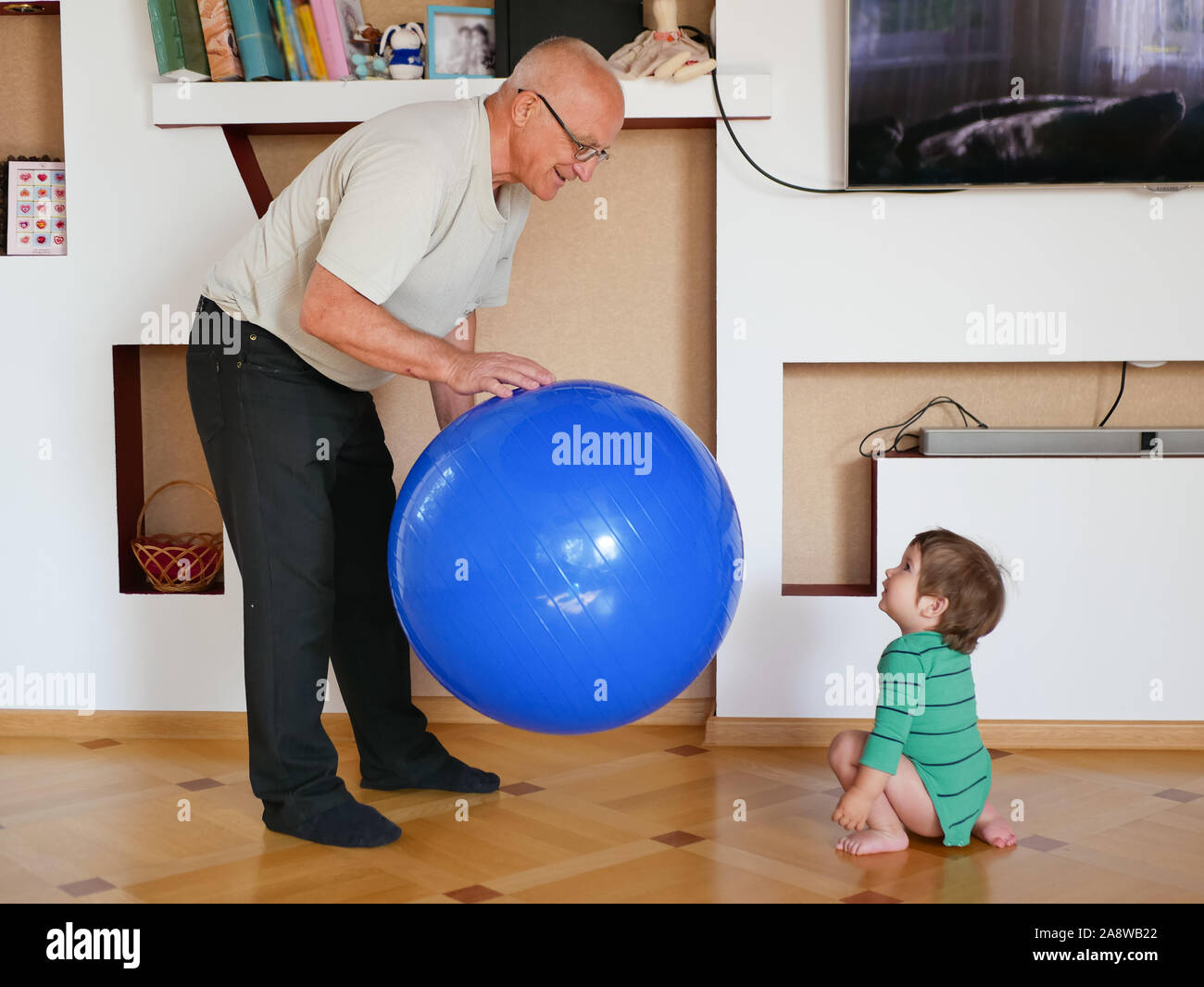 Grandfather plays ball with his grandson. The relationship between ...
