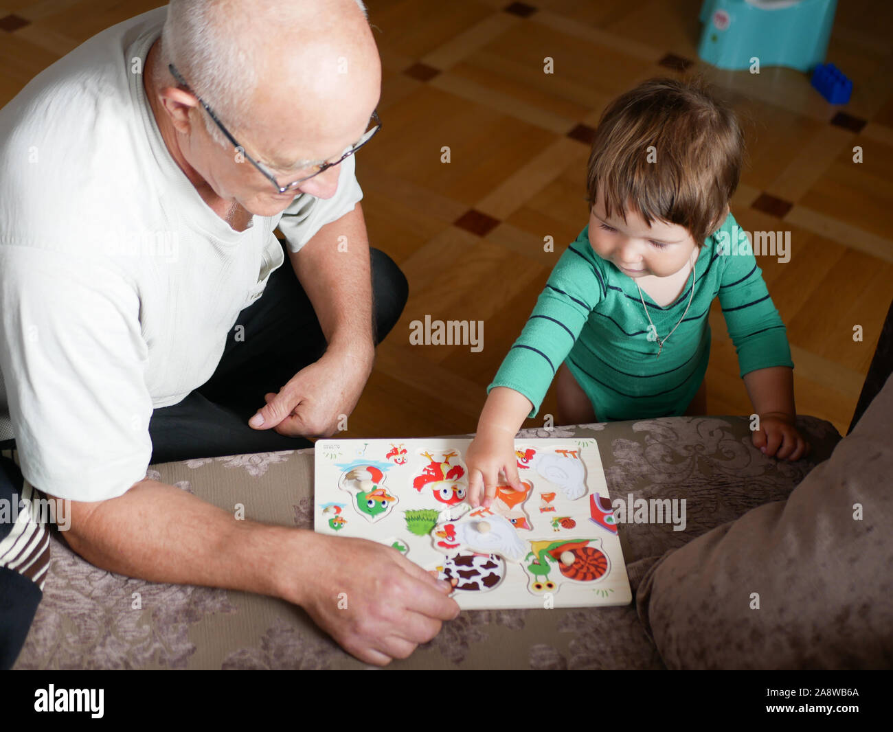 Grandfather plays ball with his grandson. The relationship between ...