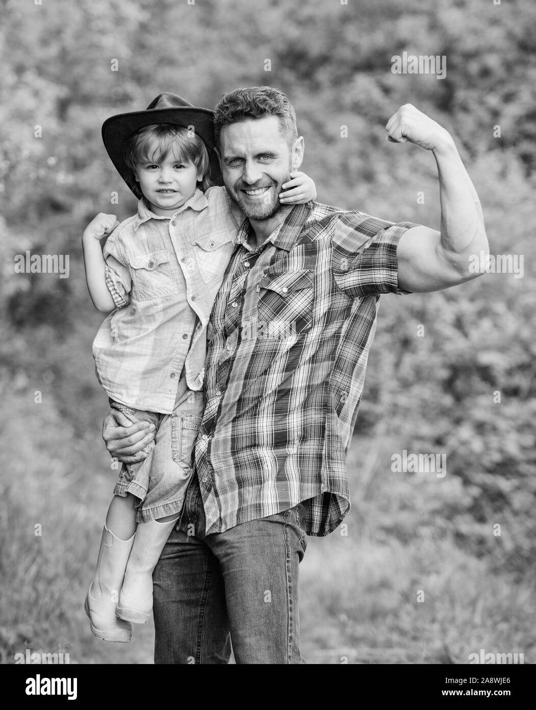 Child having fun cowboy dad. Rustic family. Growing cute cowboy. Small ...