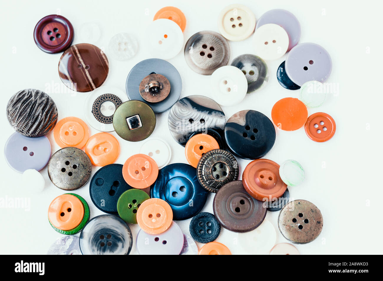 Colorful sewing buttons on white background closeup with copy space for ...