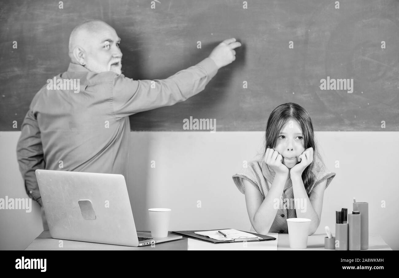 Modern education. Tired student. Senior teacher and girl school lesson ...