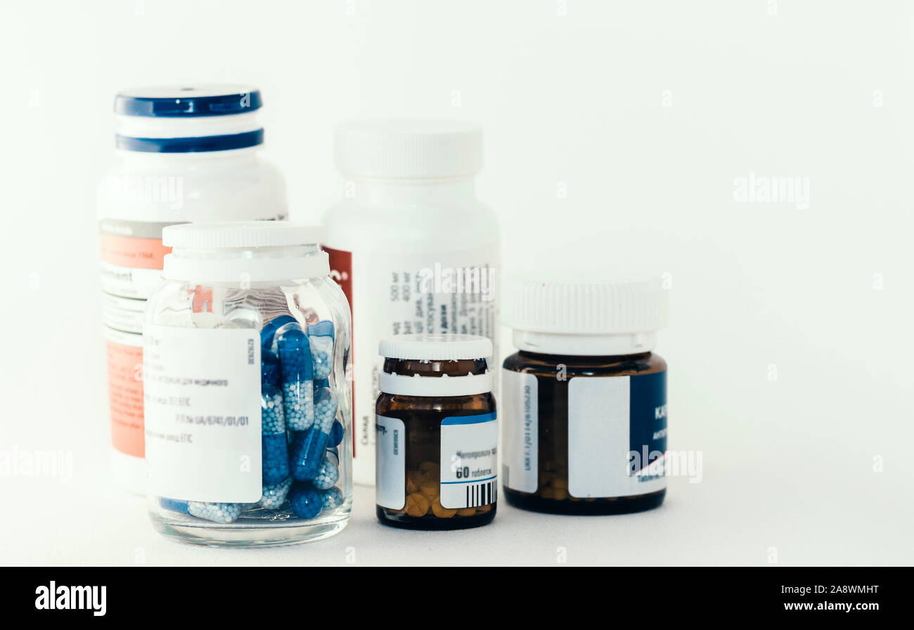 Medicine bottles with pills or capsules on white background with copy ...