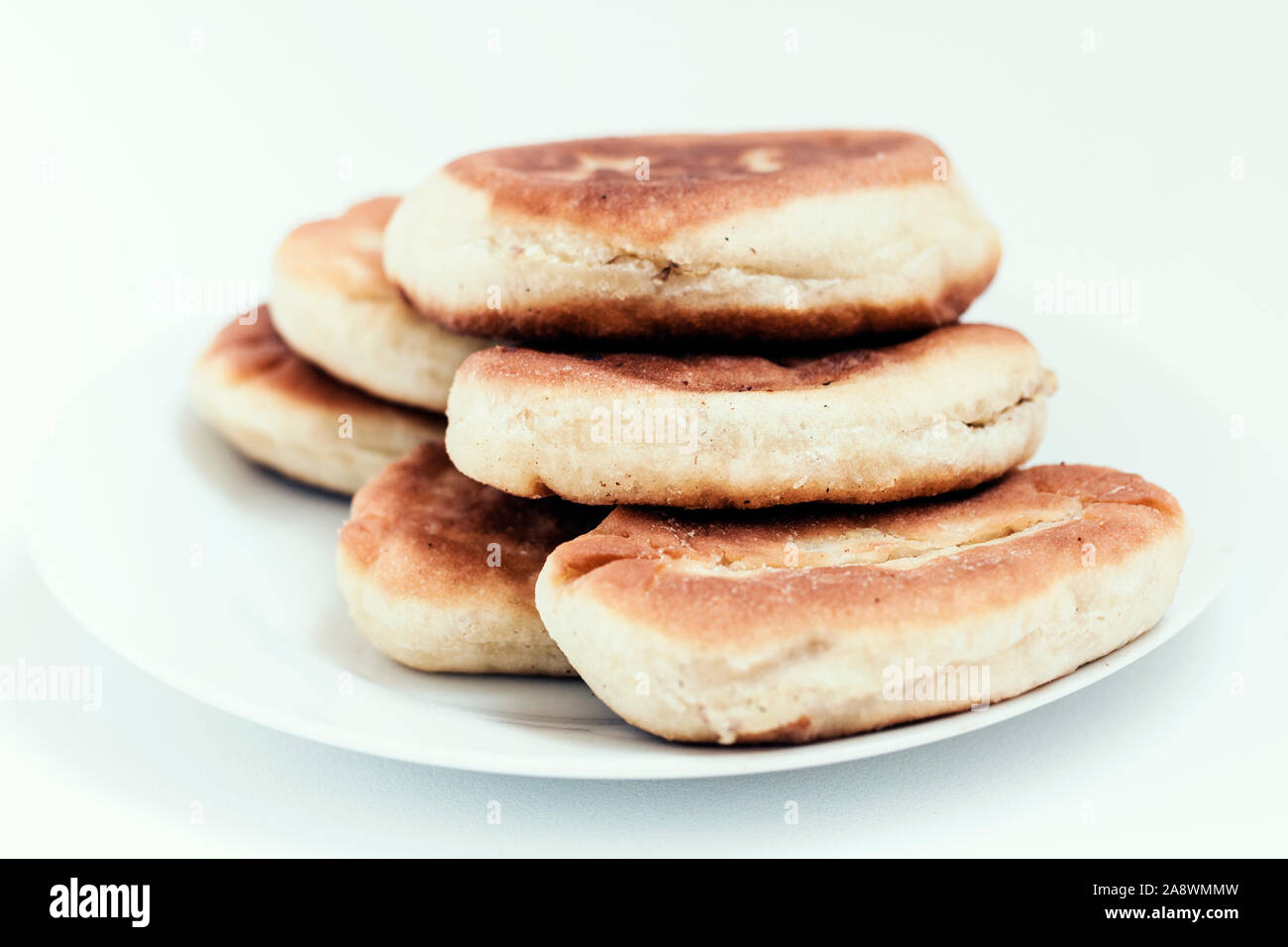 Fried cakes with potato and beans on white table background Stock Photo ...