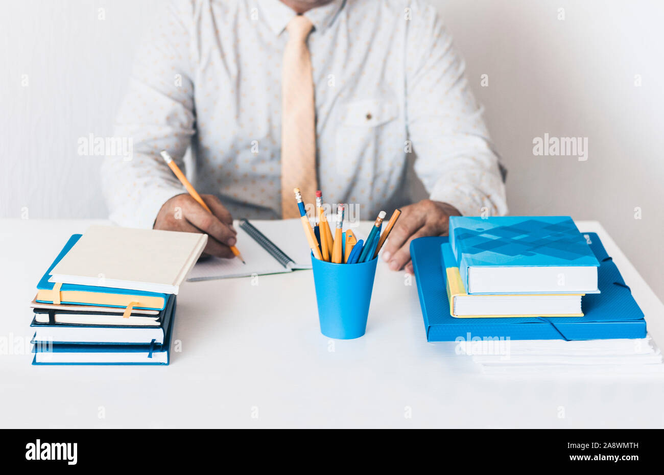 Close-up of hands middle-aged man in white shirt typing on keyboard ...