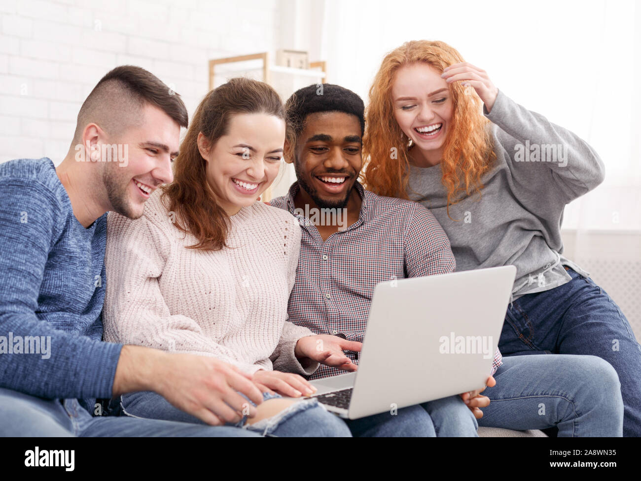 Happy students watching comedy film on laptop Stock Photo - Alamy