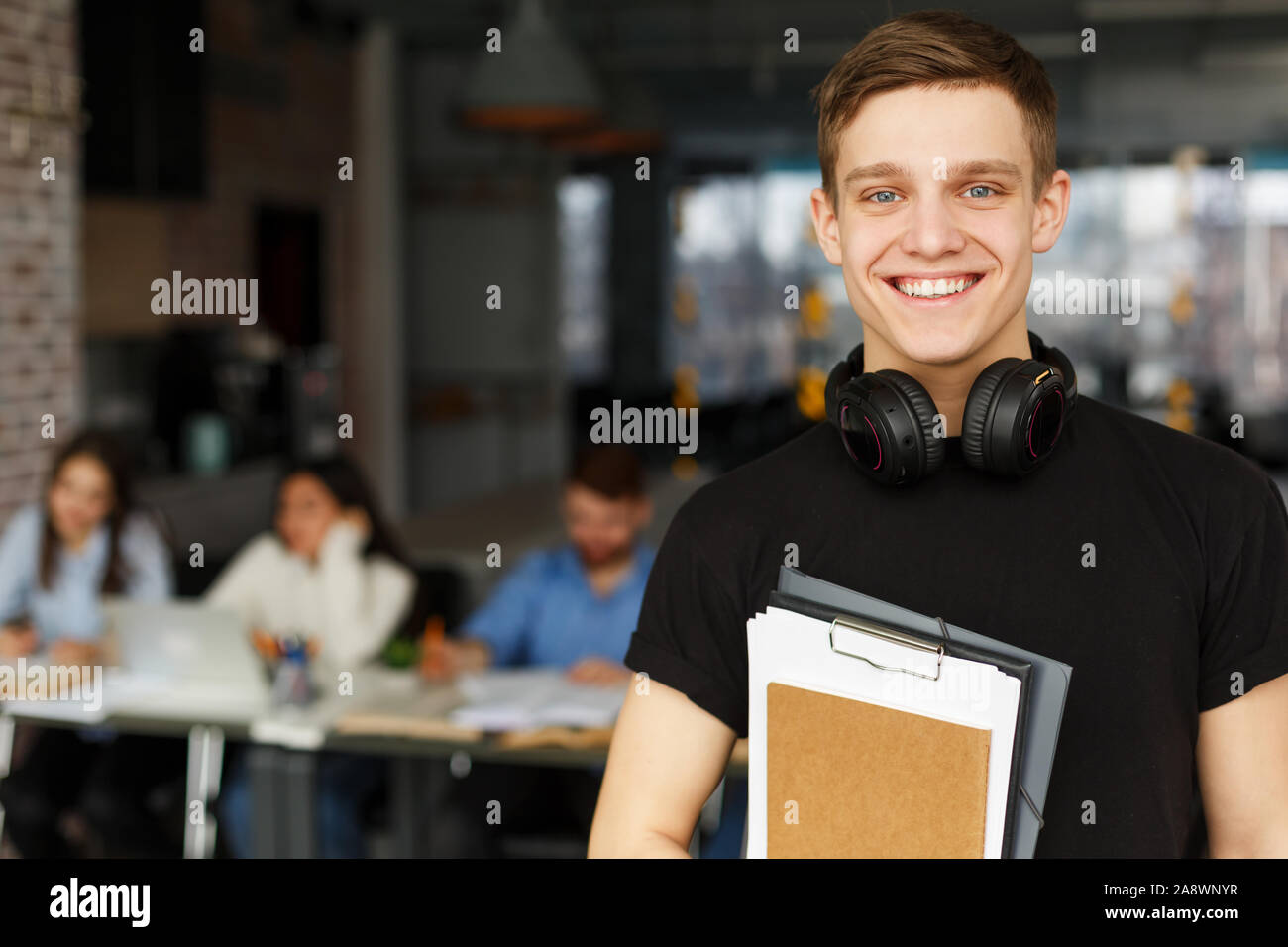 Handsome male student posing in campus library Stock Photo - Alamy