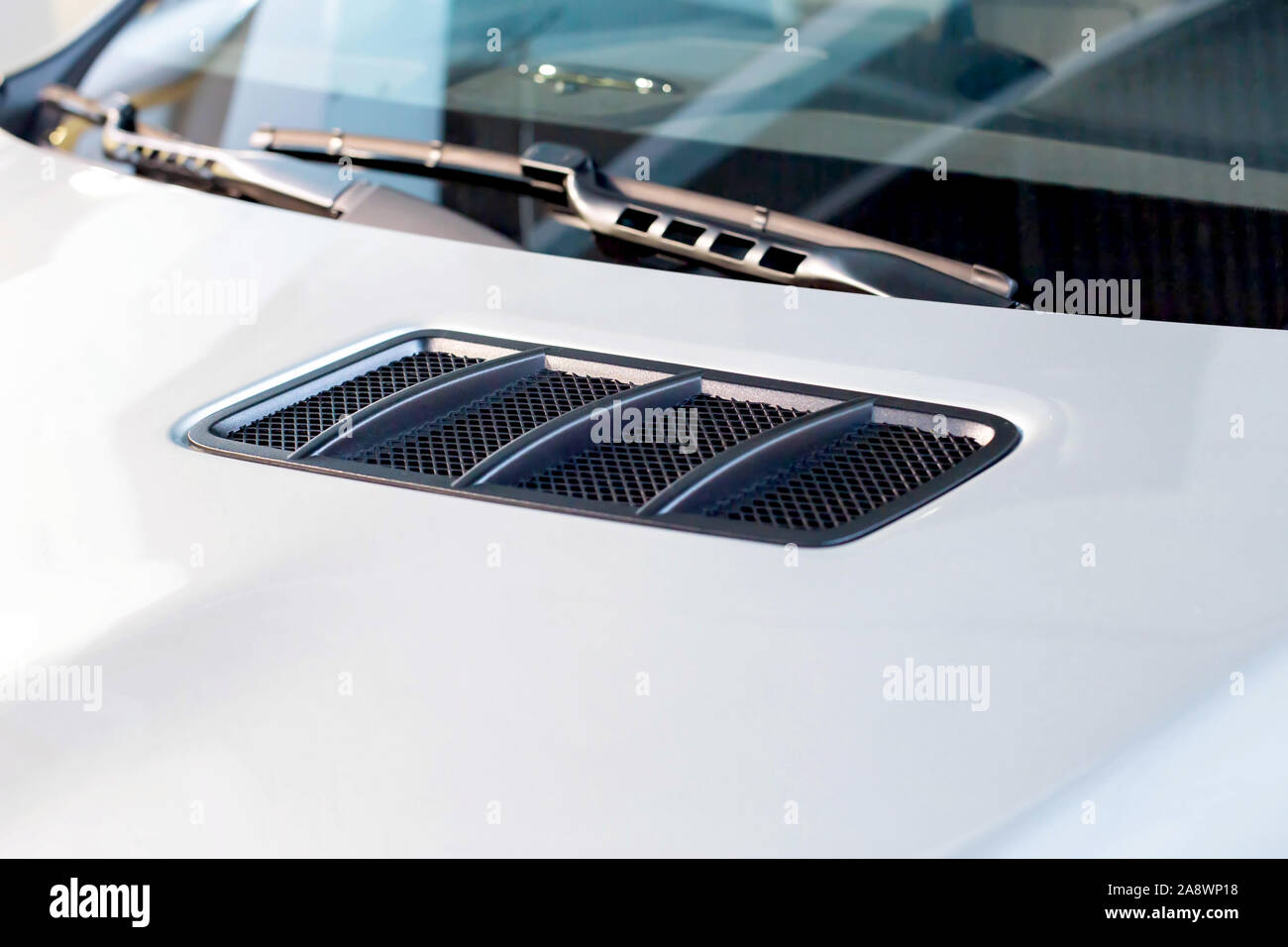 Air grille on the hood of a modern car. Blowing air, tuning a car ...