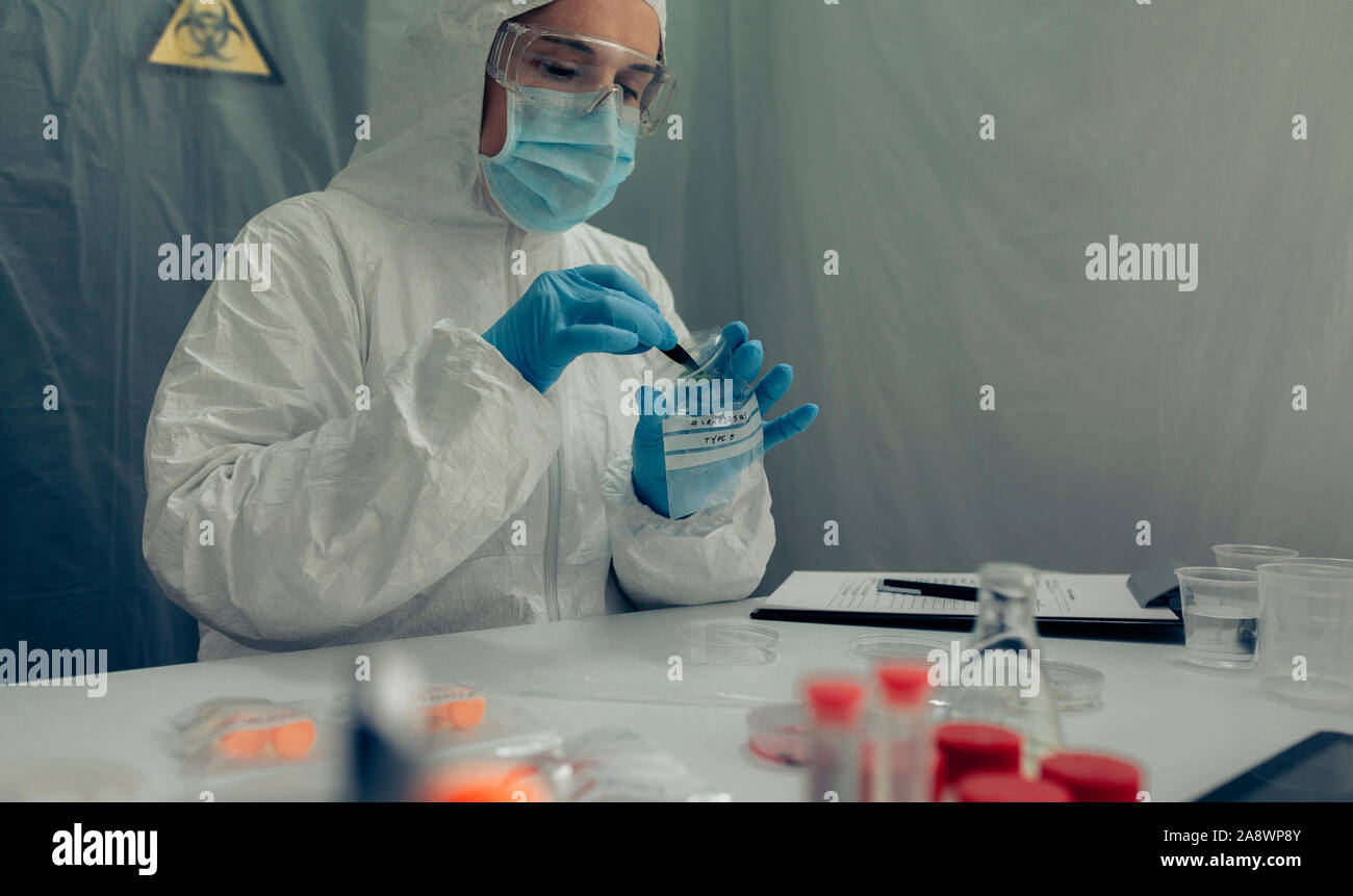 Scientist analyzing samples contaminated with virus Stock Photo - Alamy