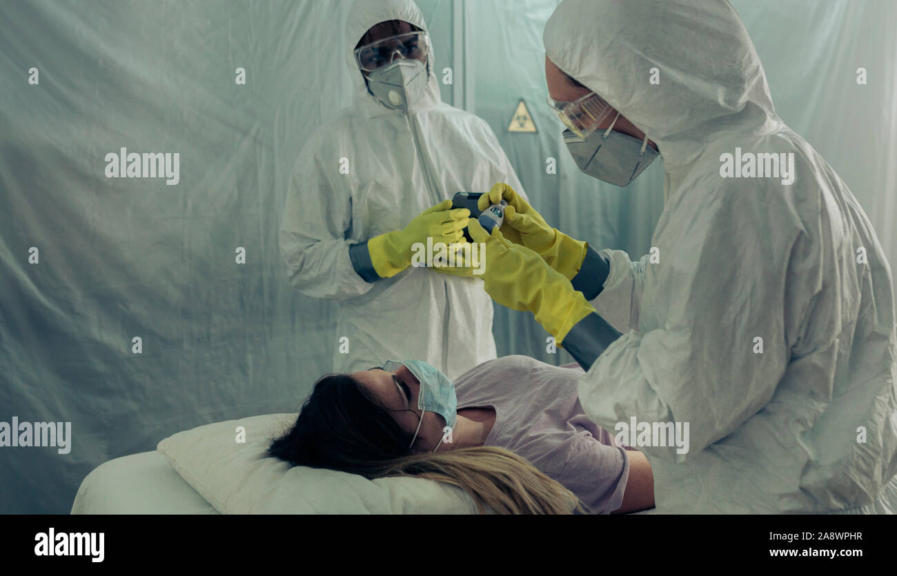People attending to a woman with a virus lying on a stretcher Stock ...