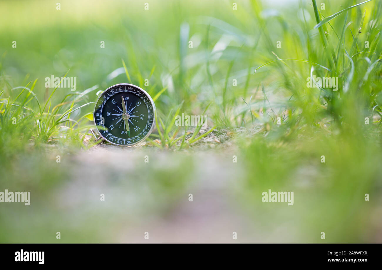 Vintage compass lying on the floor. Adventure and discovery concept ...