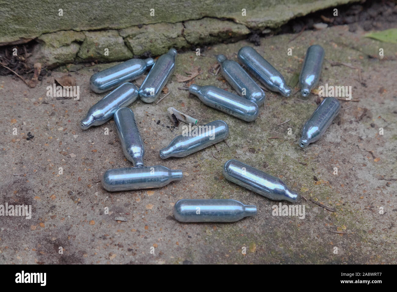 Used N2O canisters left by kerbside in South London England Stock Photo ...
