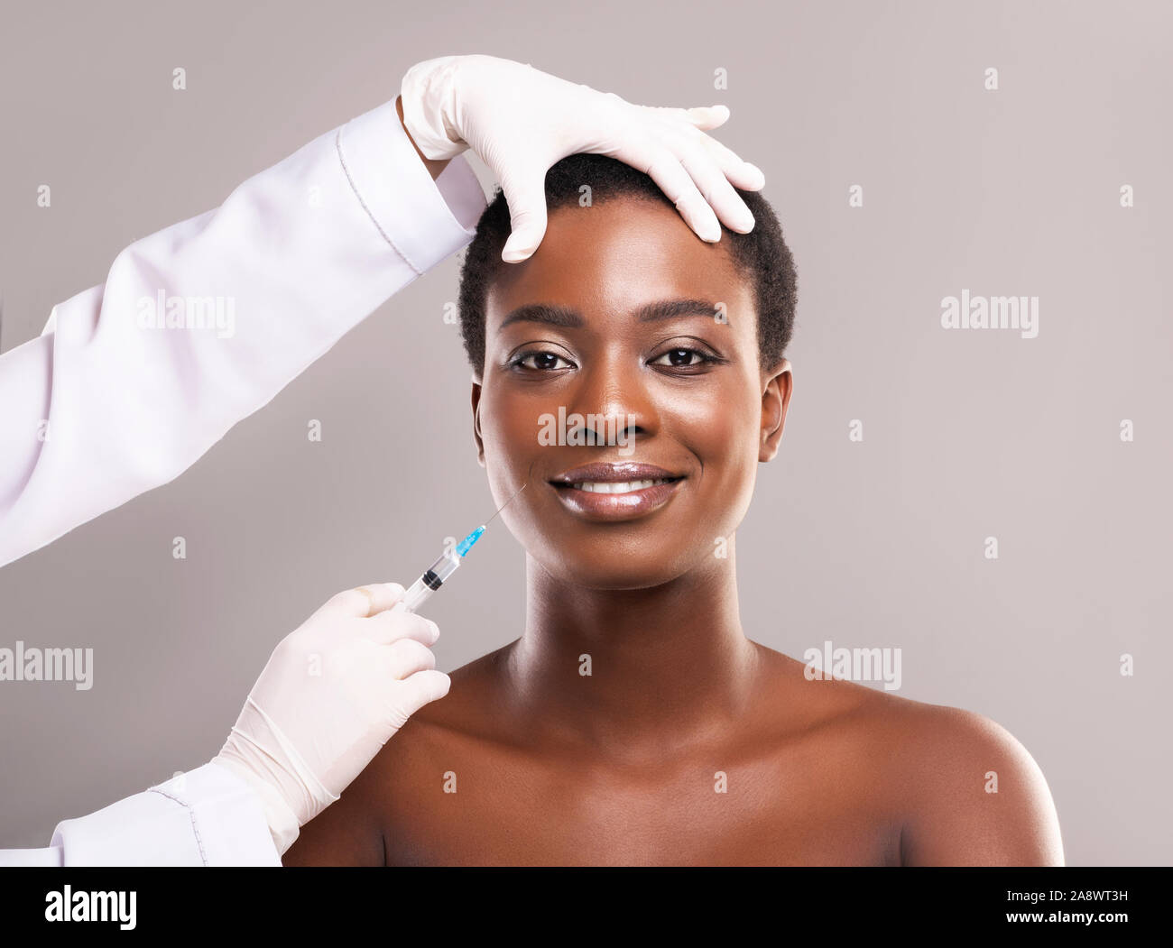 Young african woman getting beauty injection for face Stock Photo - Alamy